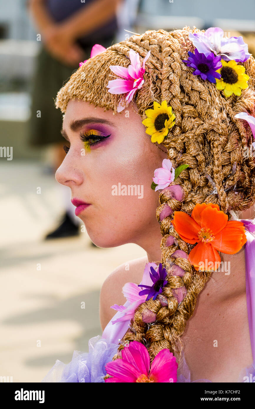 Colorful and beautiful young woman model posing as a human manikin ...