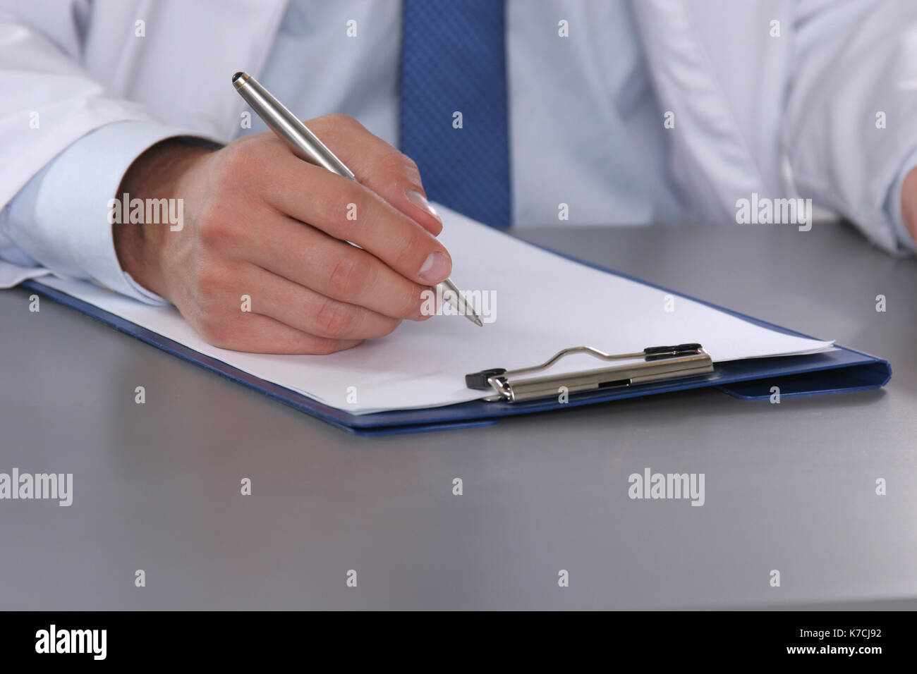 Male doctor write on the desk with test tube Stock Photo - Alamy