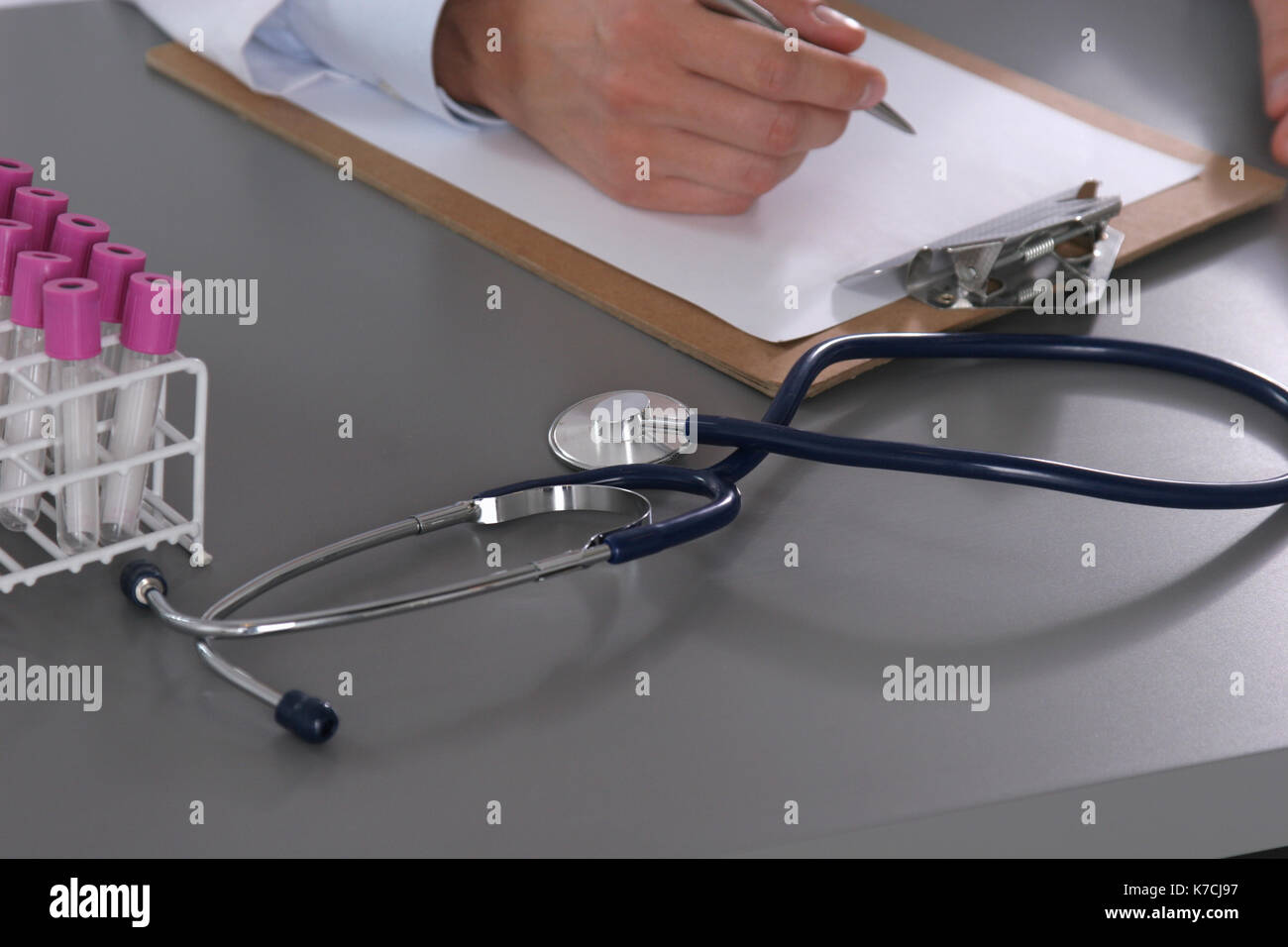 Male doctor write on the desk with test tube Stock Photo - Alamy