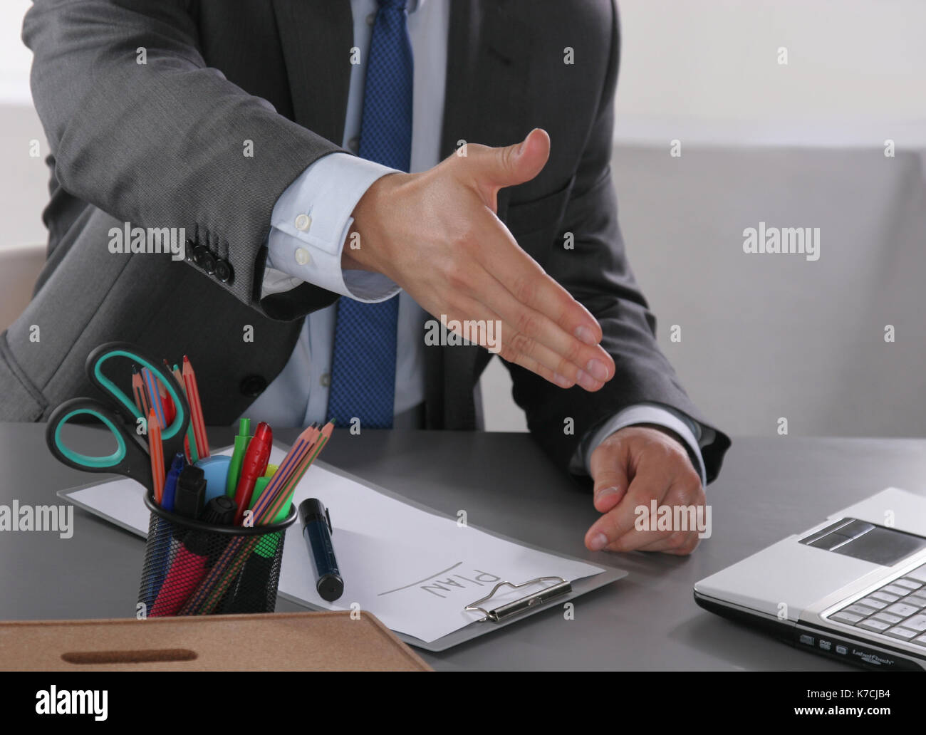 Businessman ready to shake hand in office Stock Photo - Alamy