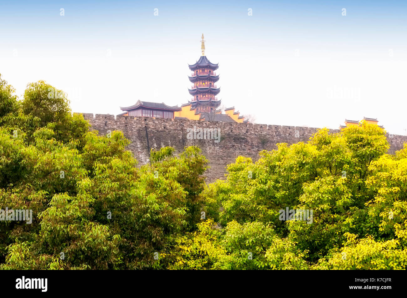 Jiming Temple rising above the historic wall in the city of Nanjing ...
