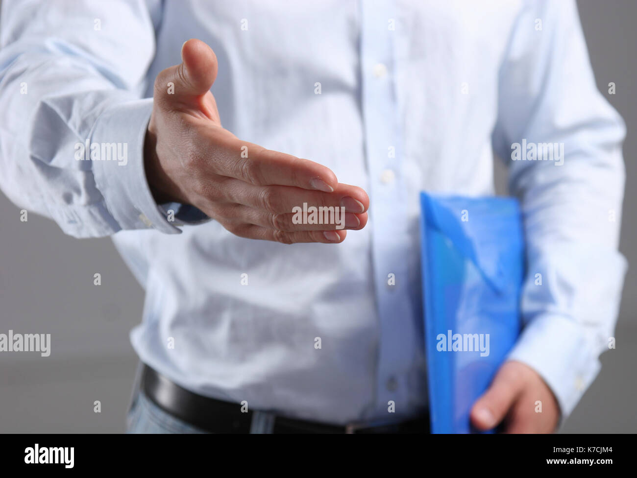 Businessman offering his hand for handshake Stock Photo - Alamy