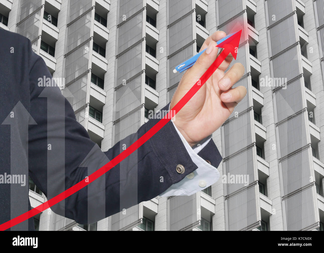 hand of businessman using blue pen pointing to top business graph on ...