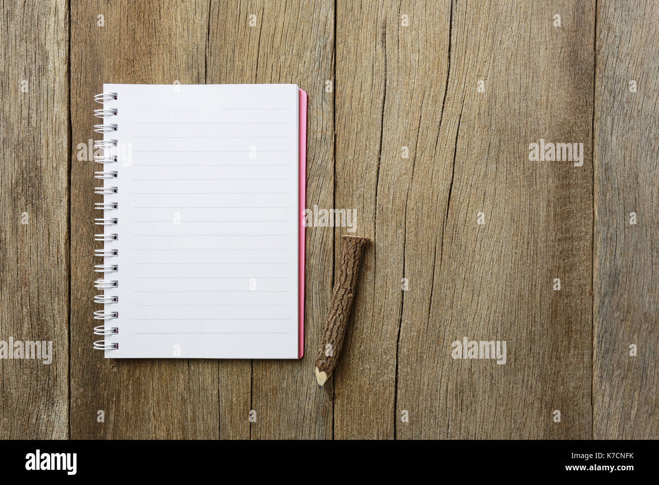 notepad book is placed on a brown wooden floor for design in your work ...