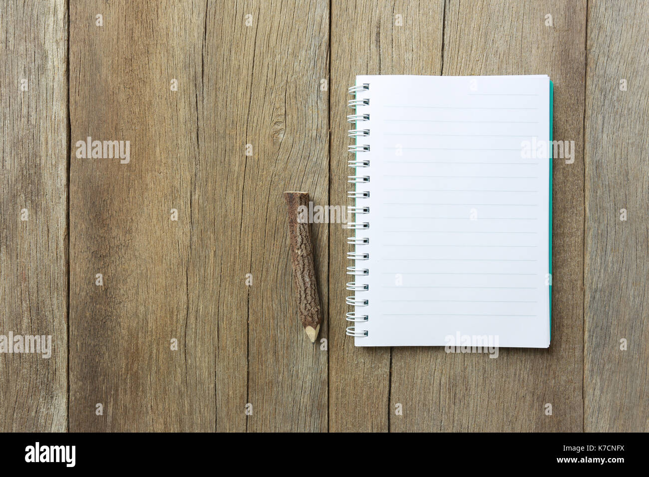notepad book is placed on a brown wooden floor for design in your work ...