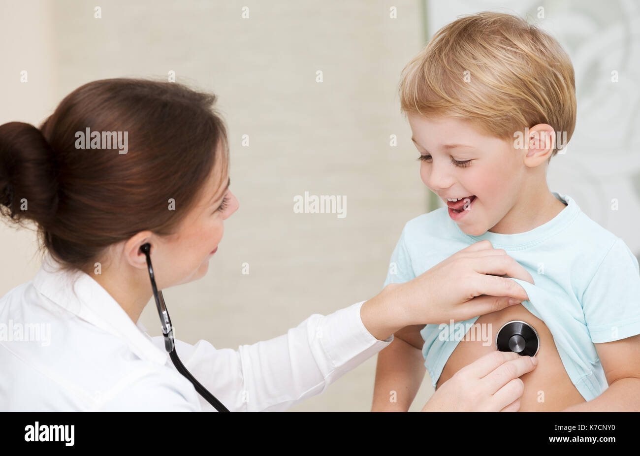 Cute little boy with pleasure visiting pediatrician, scheduled checkup ...
