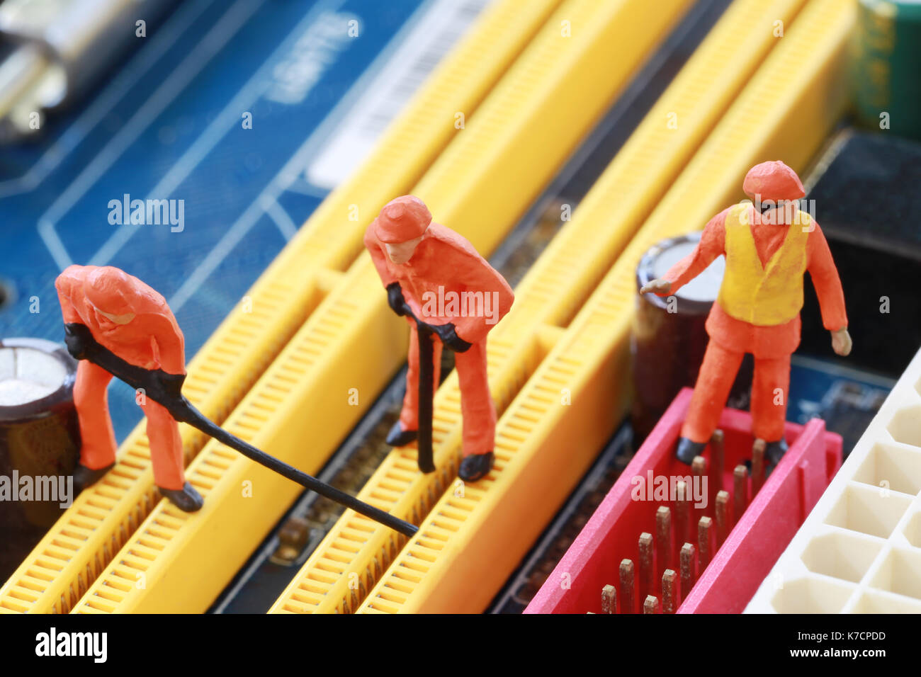 Idea of a worker is miners are digging for ore on computer mainboard in ...
