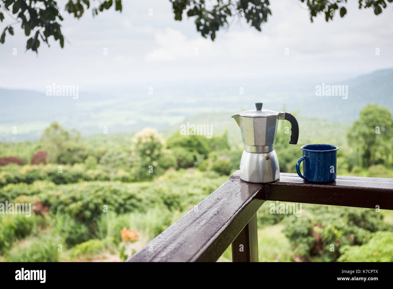 Moka pot stand with blue cup with green environment in background Stock ...