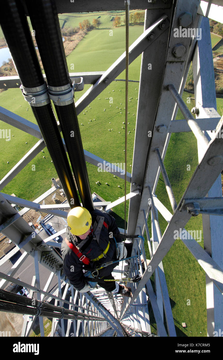 Aerial riggers and engineers working on a telecoms telecommunications ...