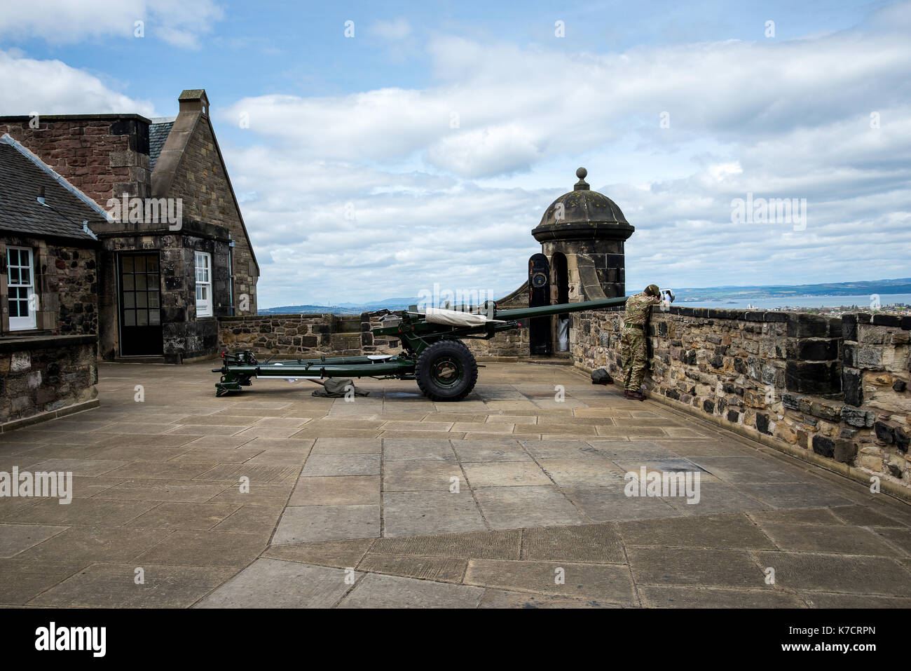 A gunner is cleaning One O'Clock gun in Edinburgh Castle, Scotland ...