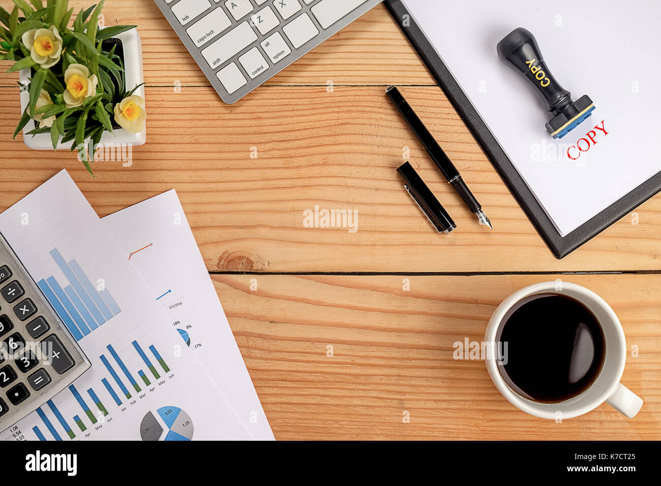 Office desk table with chart calculator notebook pen glasses and flower ...