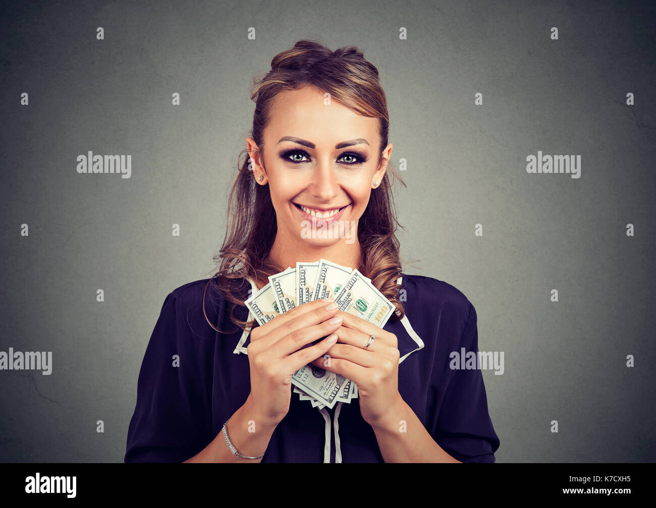 Woman holding money spending hi-res stock photography and images - Alamy