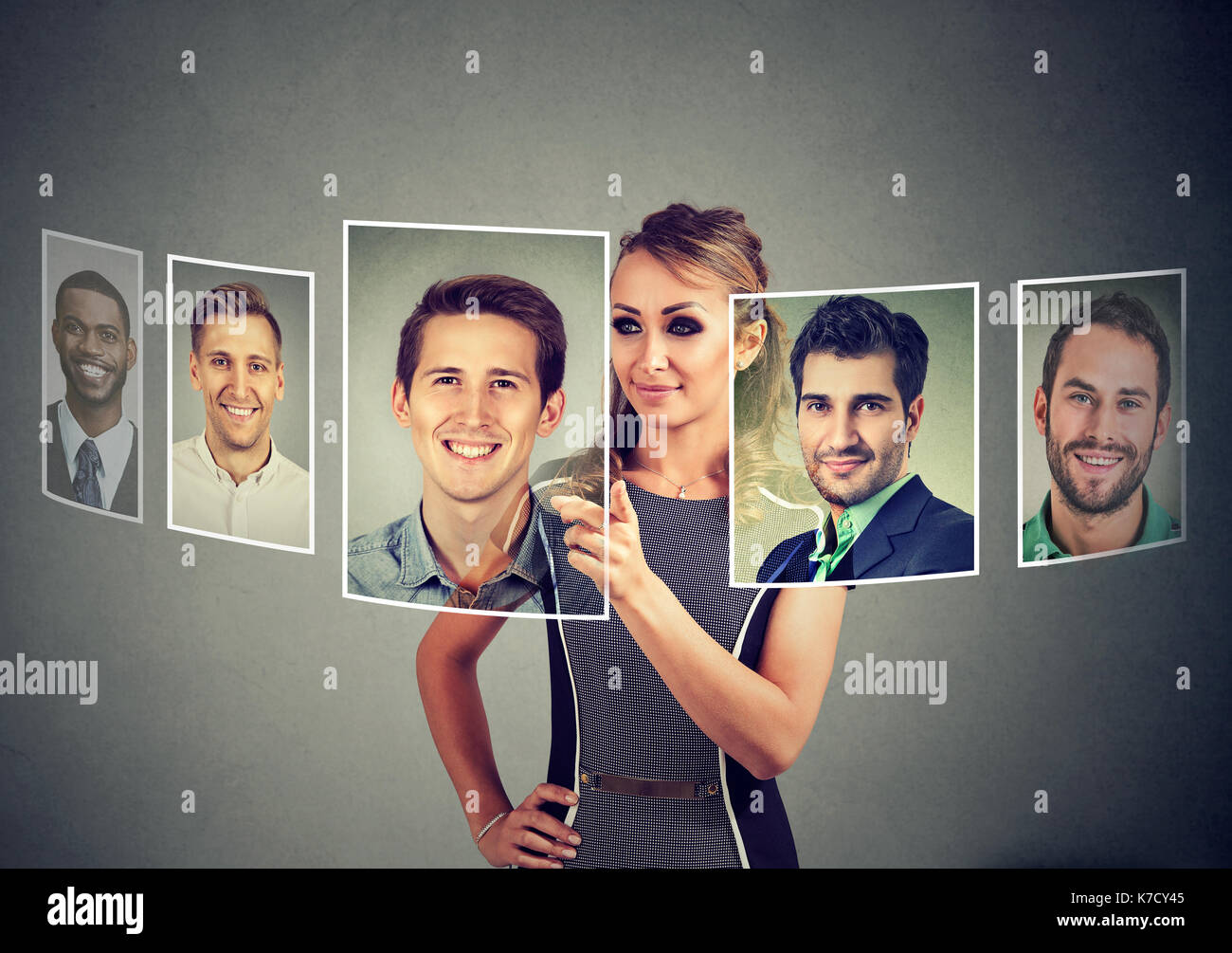 Beautiful young woman undecided which man to choose Stock Photo - Alamy