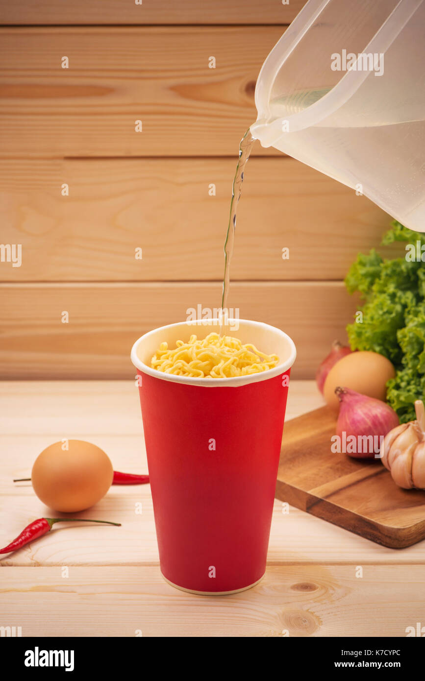Cooking instant noodles in cup, boiling water Stock Photo - Alamy
