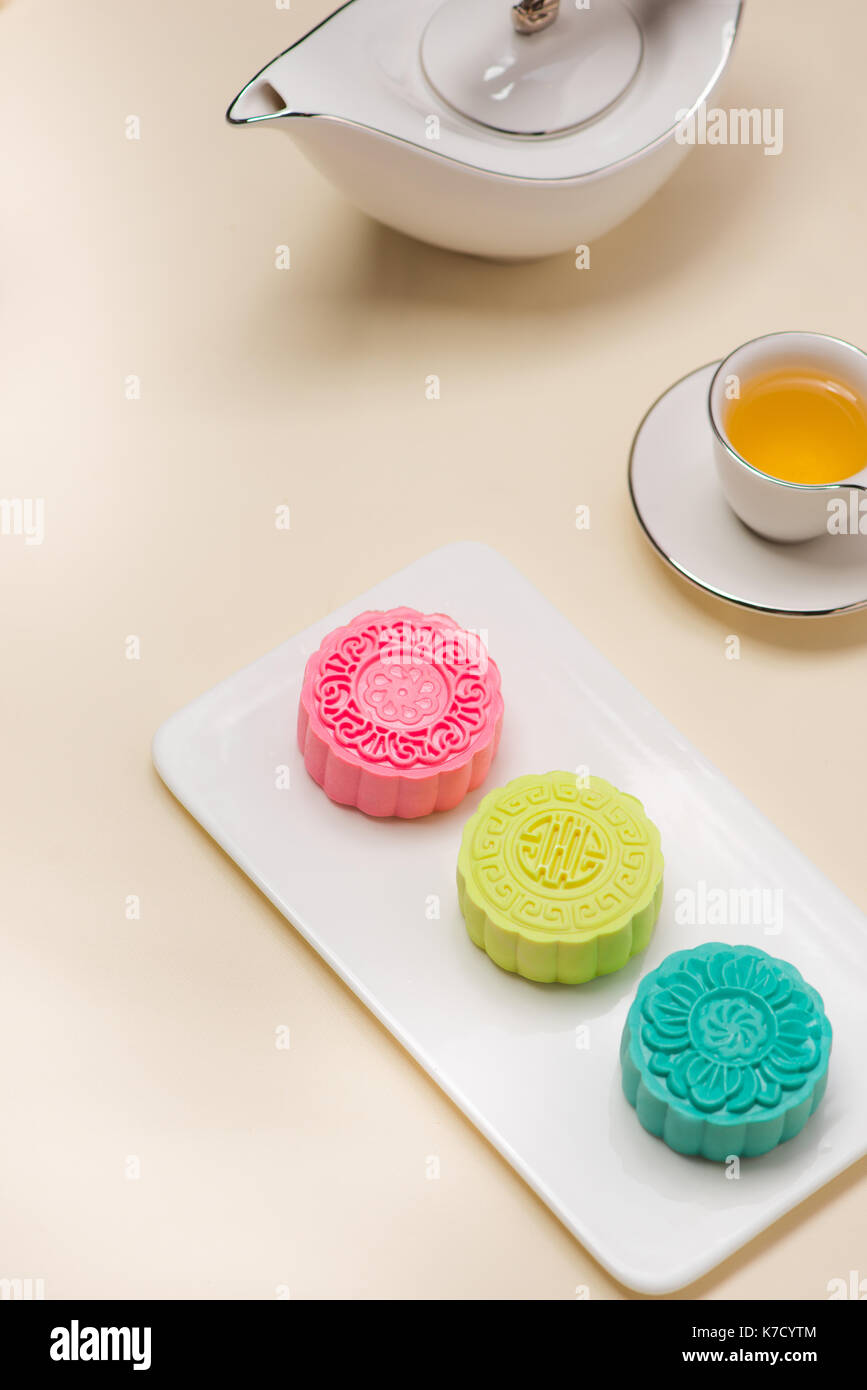 Colorful snow skin mooncake with tea pot on pink background Stock Photo ...