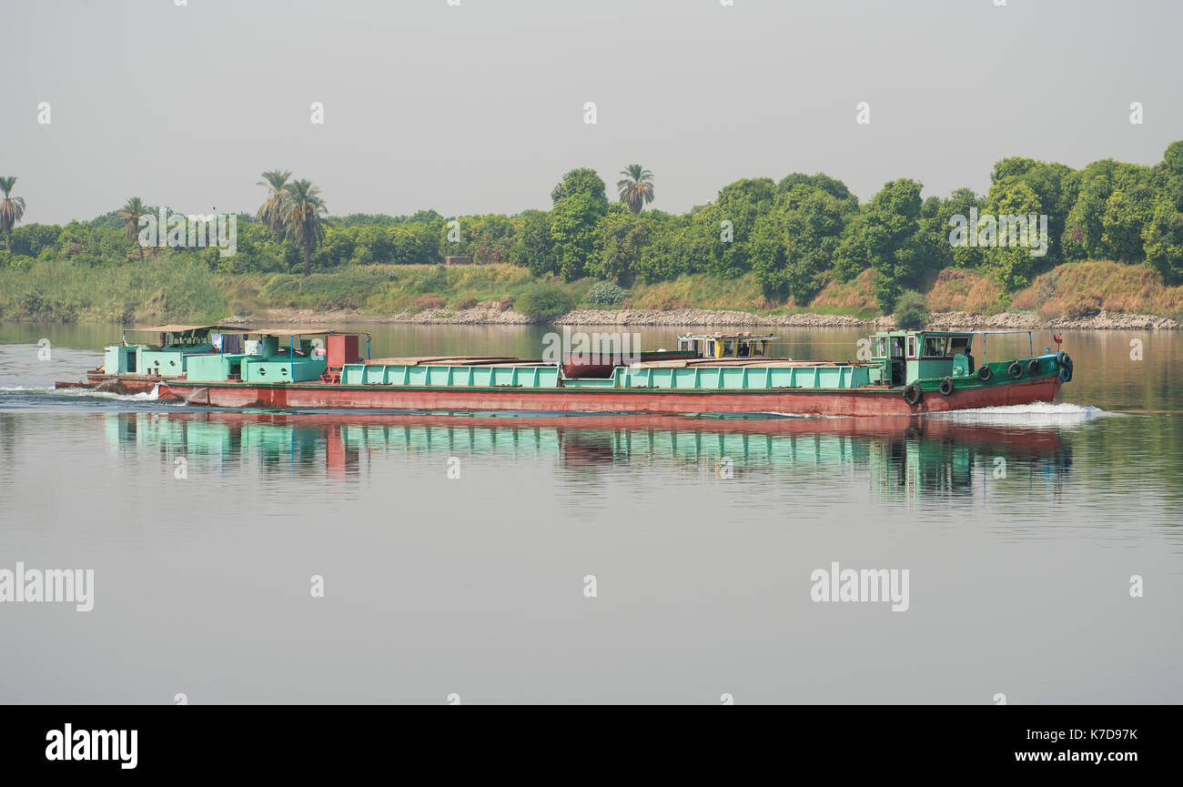Old large traditional barge boat traveling on river Nile through rural ...