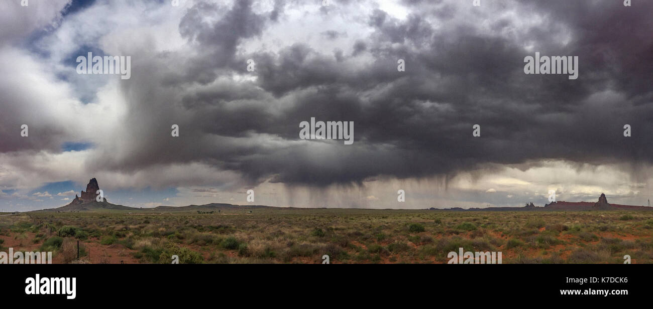 Storm clouds raining over Monument Valley Stock Photo - Alamy