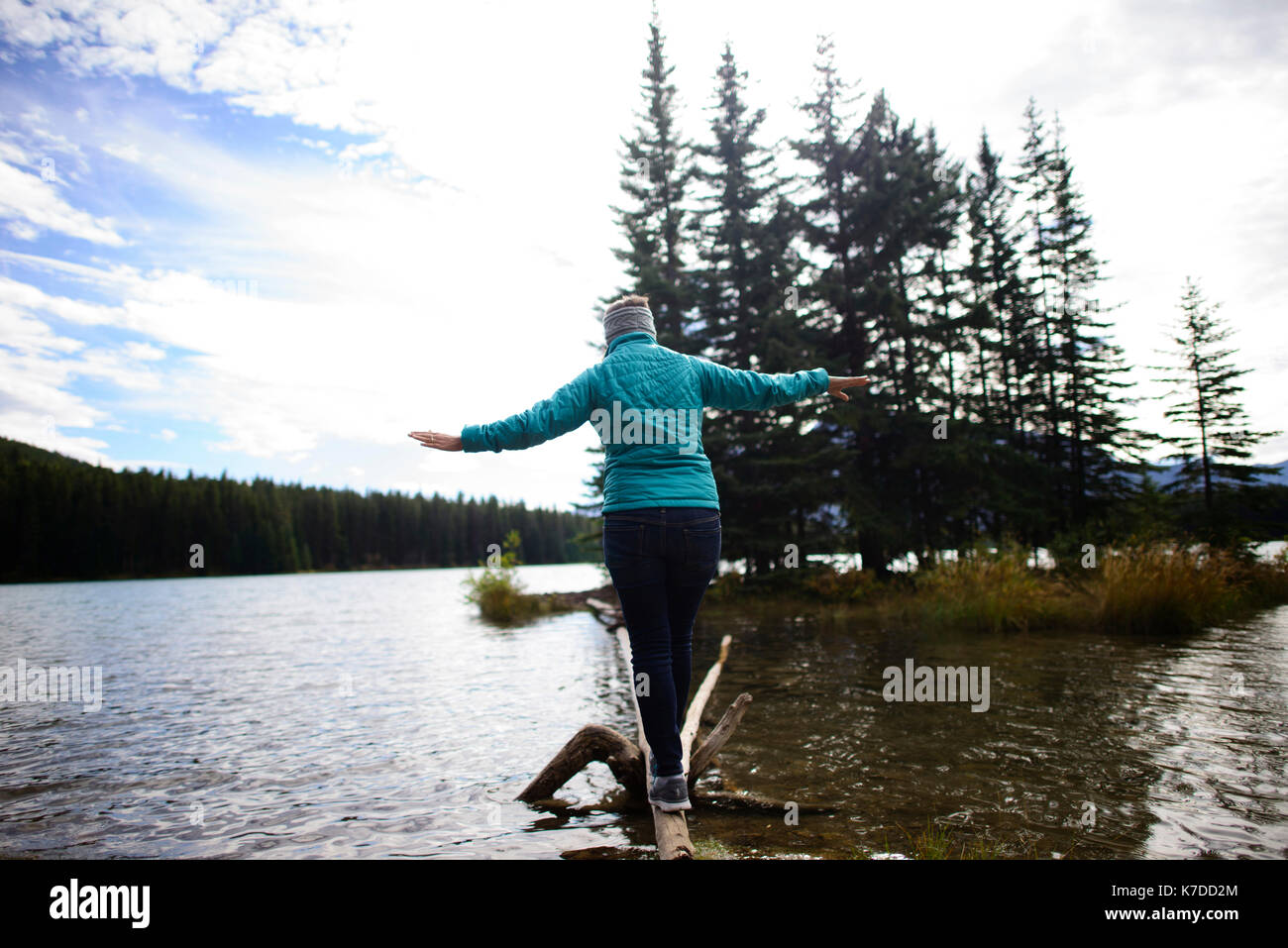 Woman balancing on log by lake hi-res stock photography and images - Alamy