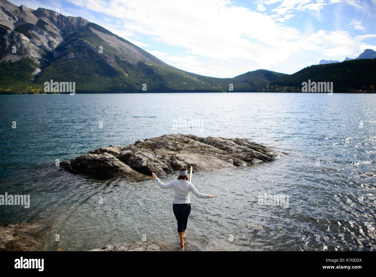 Woman balancing on log by lake hi-res stock photography and images - Alamy