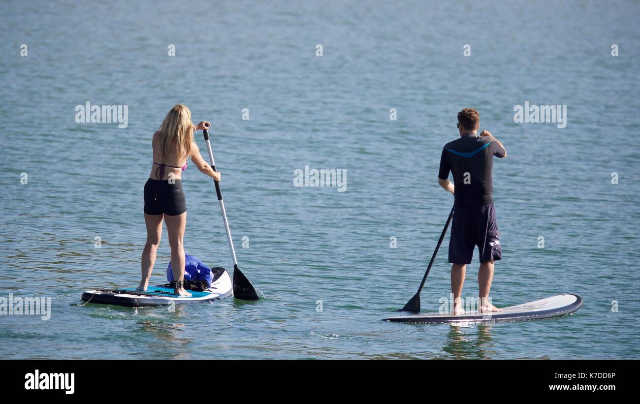 Two people paddle boarding Stock Photo - Alamy