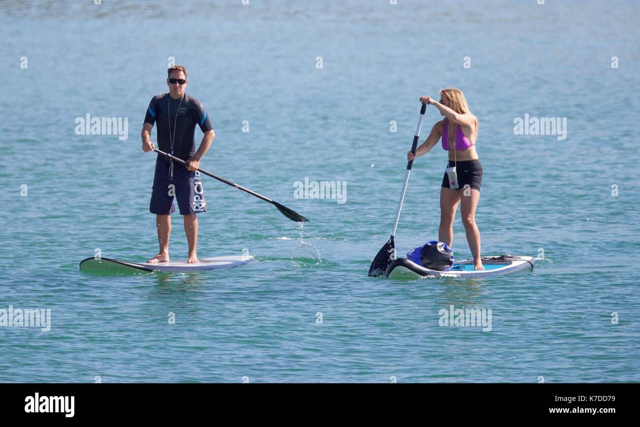 Two people paddle boarding Stock Photo - Alamy