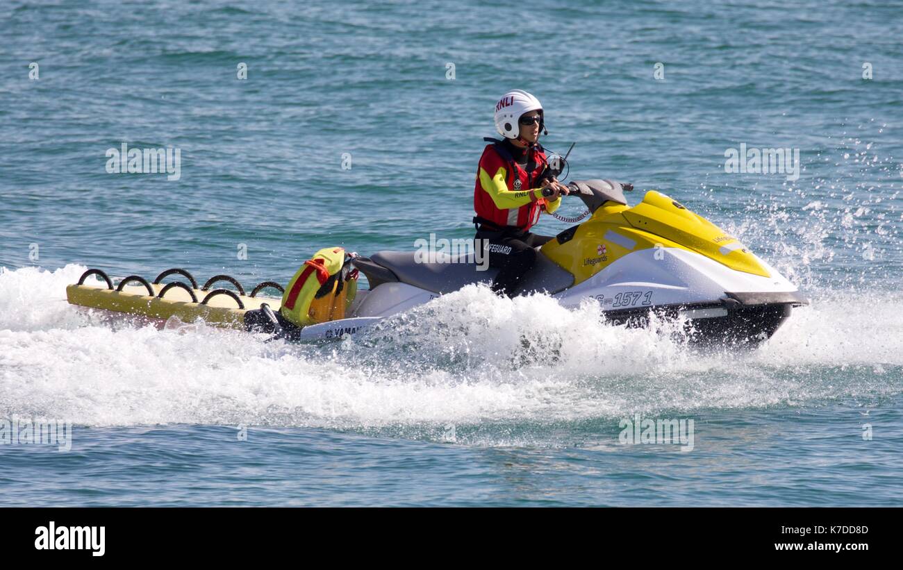 RNLI Lifeguard on a jetski patrolling Bournemouth Stock Photo - Alamy
