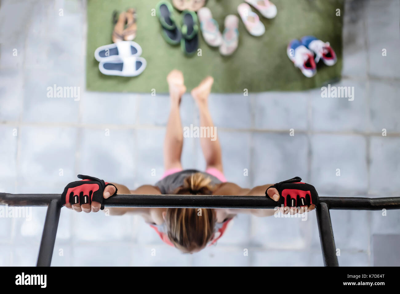 Overhead view of man hanging on gymnastics bar at health club Stock ...