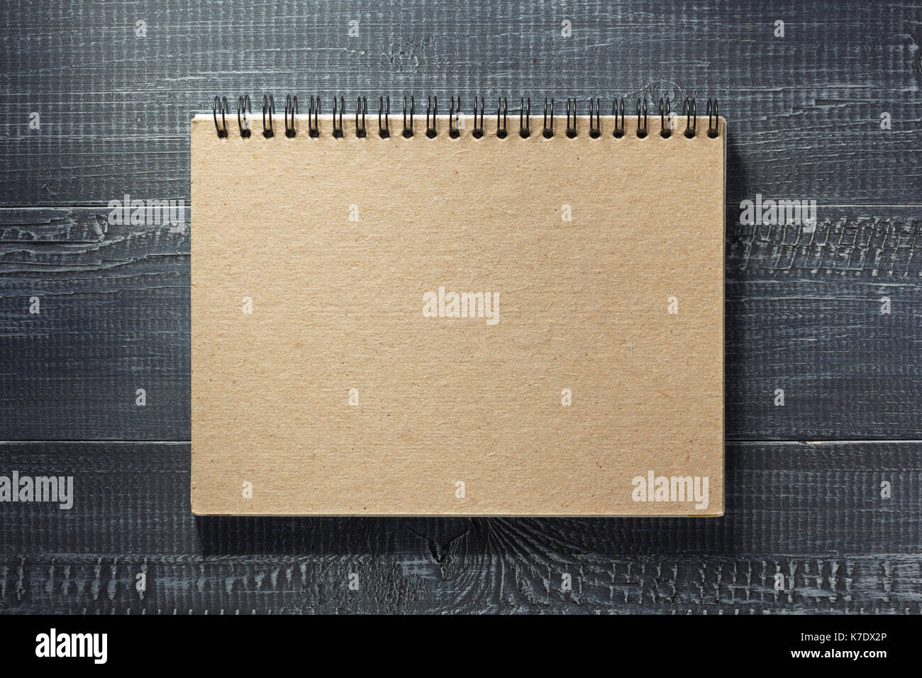 checked notebook at wooden background texture Stock Photo - Alamy