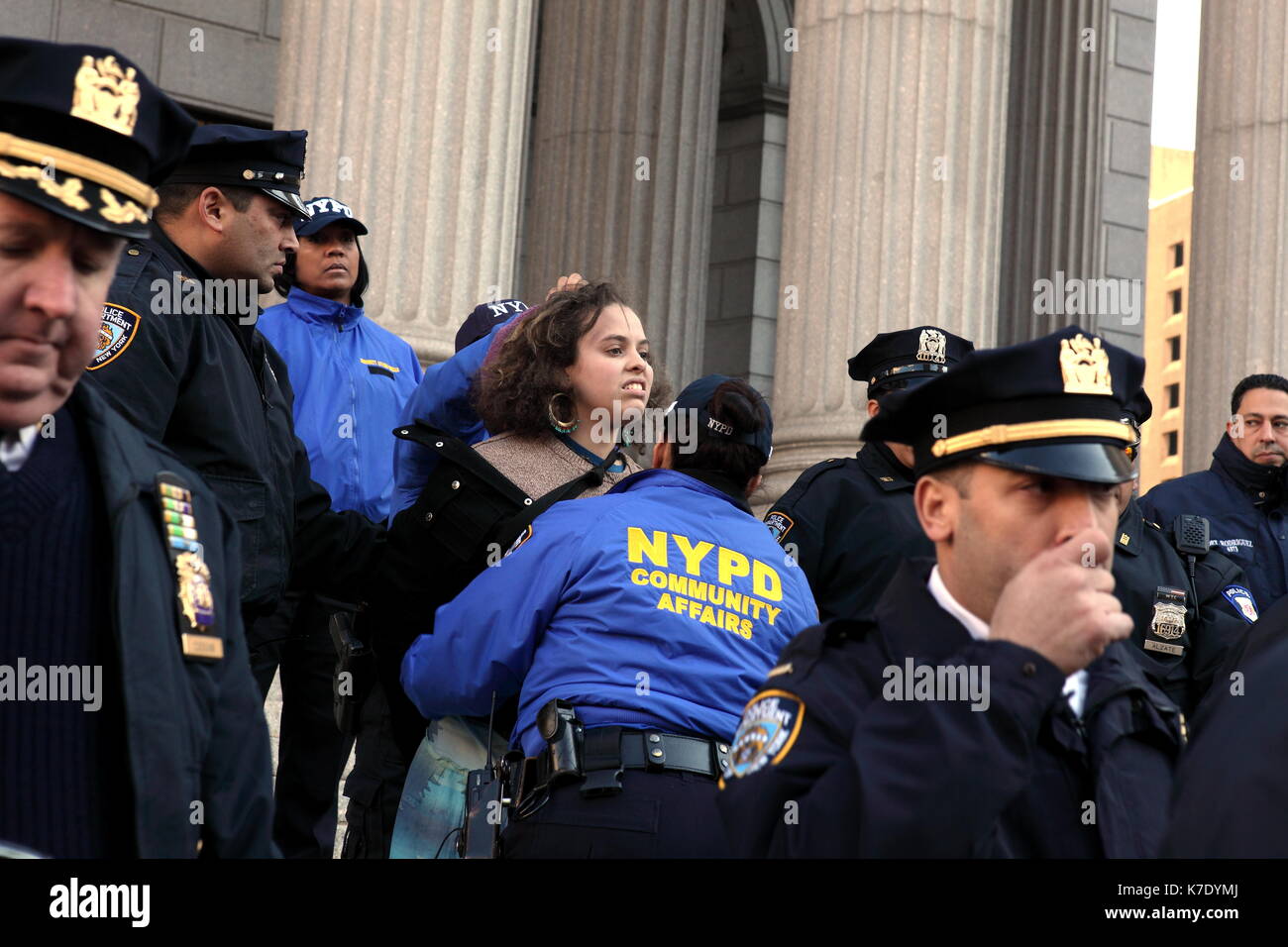 Nypd Officers Arrest A Young Woman As She Attempts To Stand On The