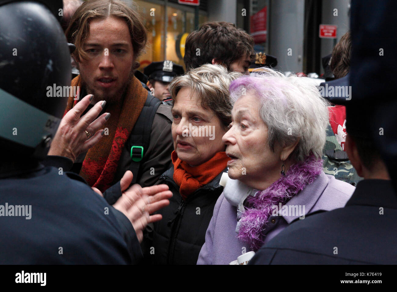 Frances Goldin, 87, (center right) argues with NYPD officers and ...