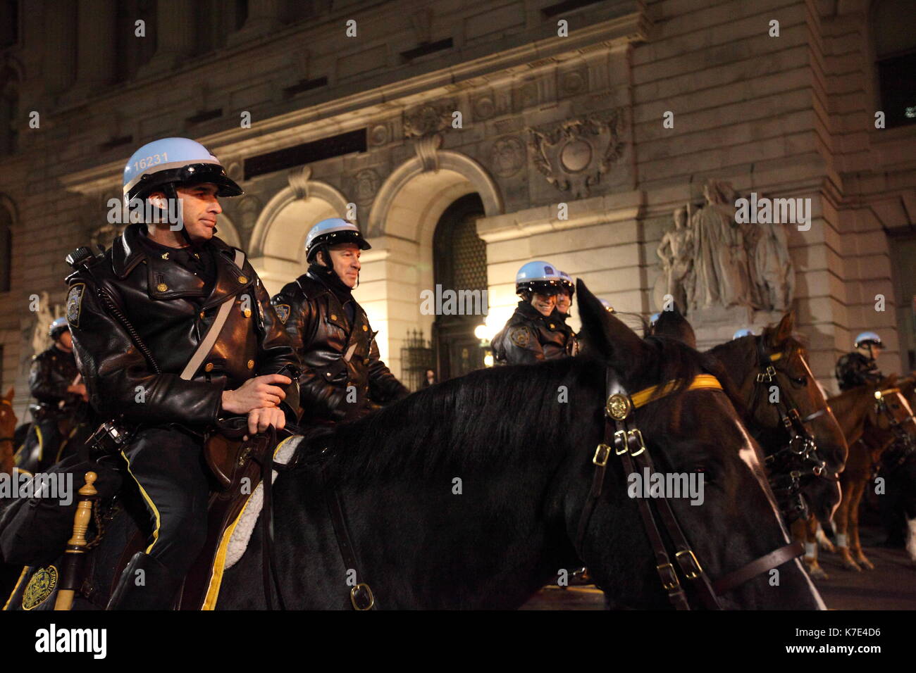 Mounted NYPD police officers stand guard at the Brooklyn Bridge as the ...