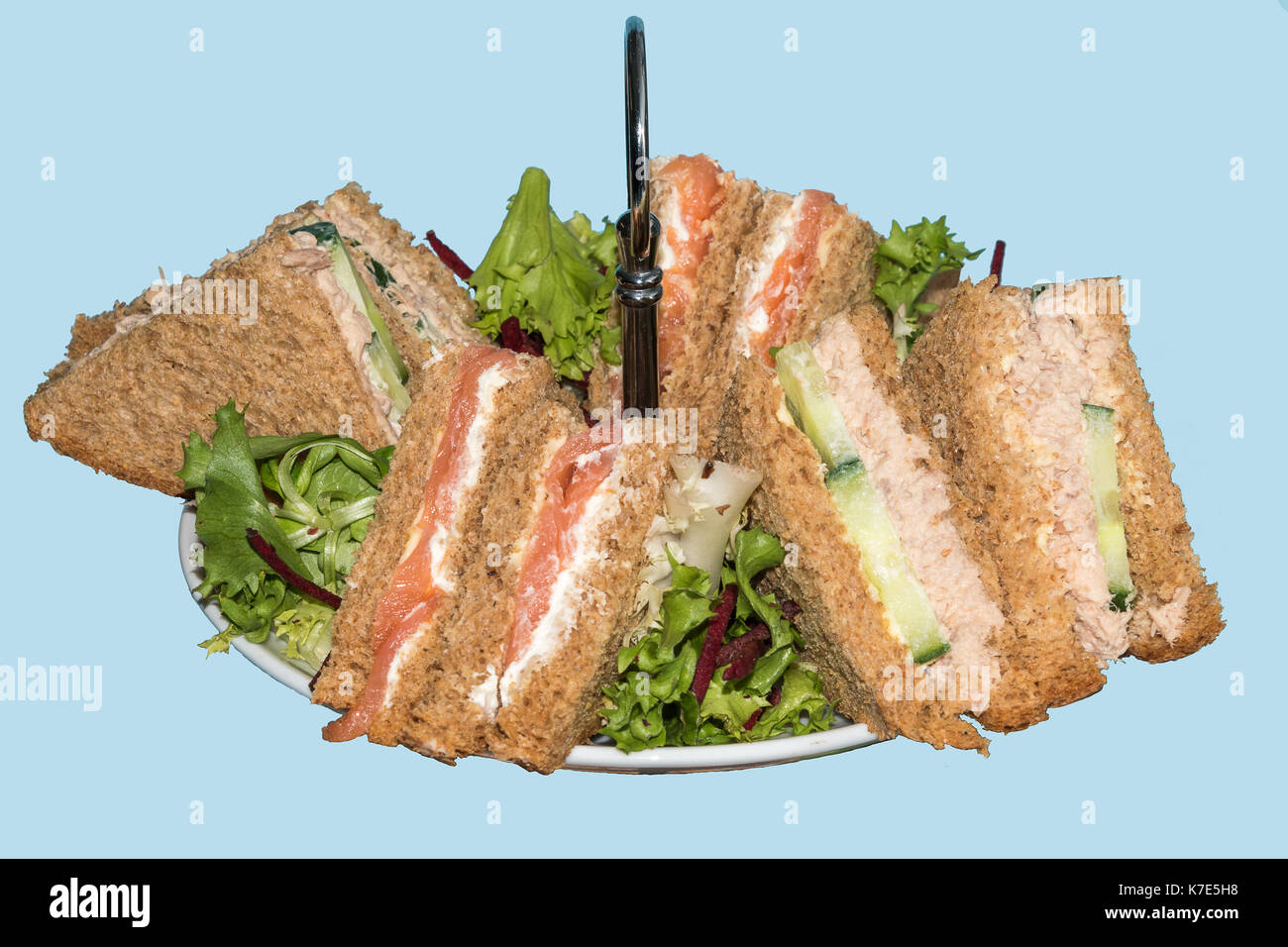 Afternoon Tea sandwiches on a stand isolated on a blue background Stock ...