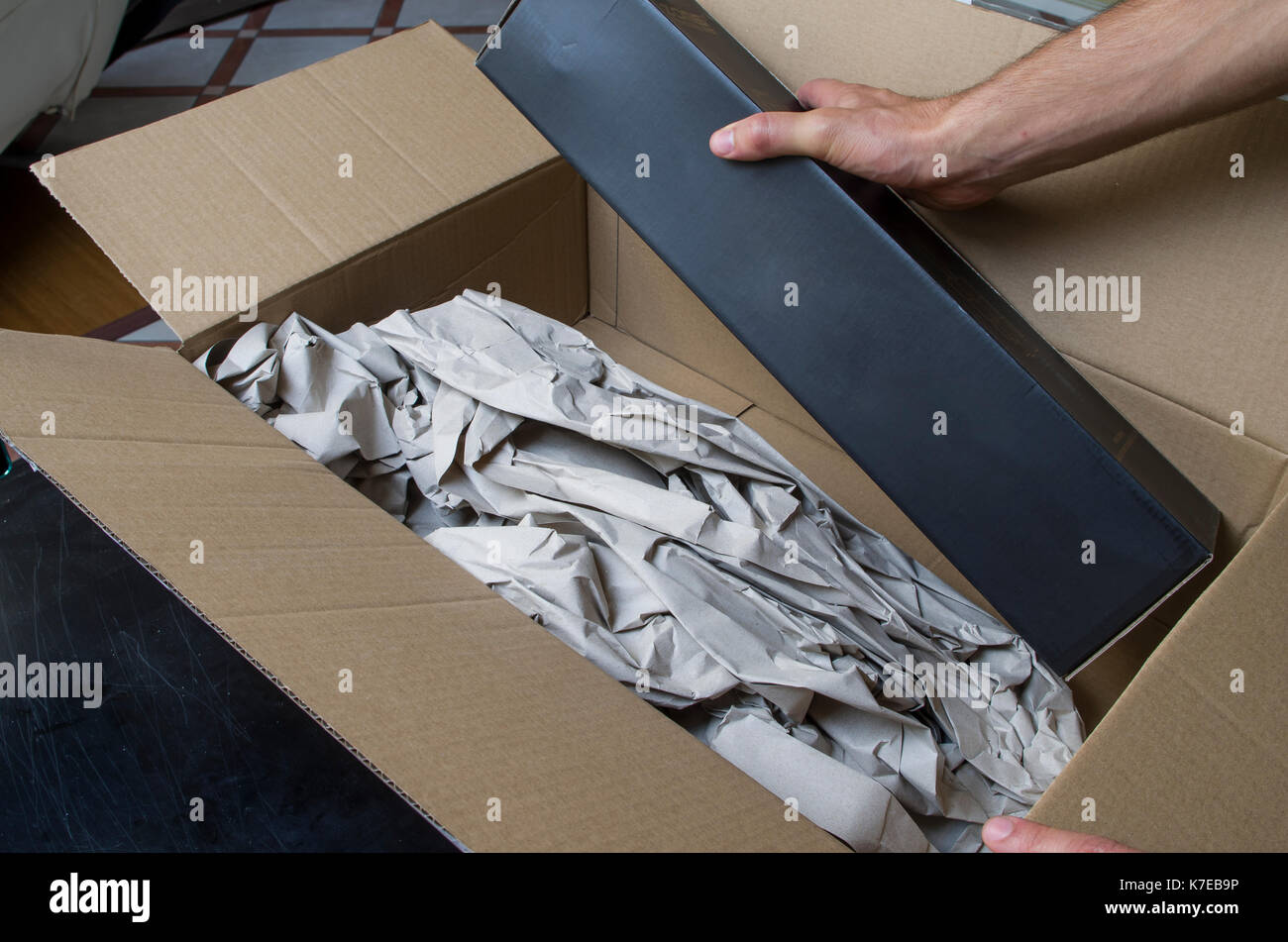 Unpacking a delivery. Hands opening a shipping box Stock Photo - Alamy