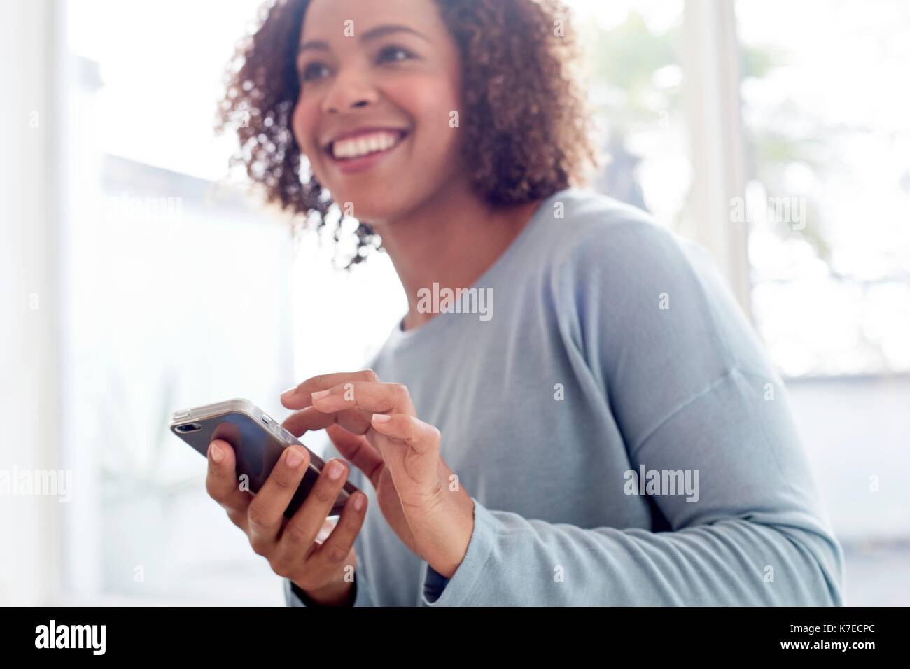 Woman with phone looking away hi-res stock photography and images - Alamy