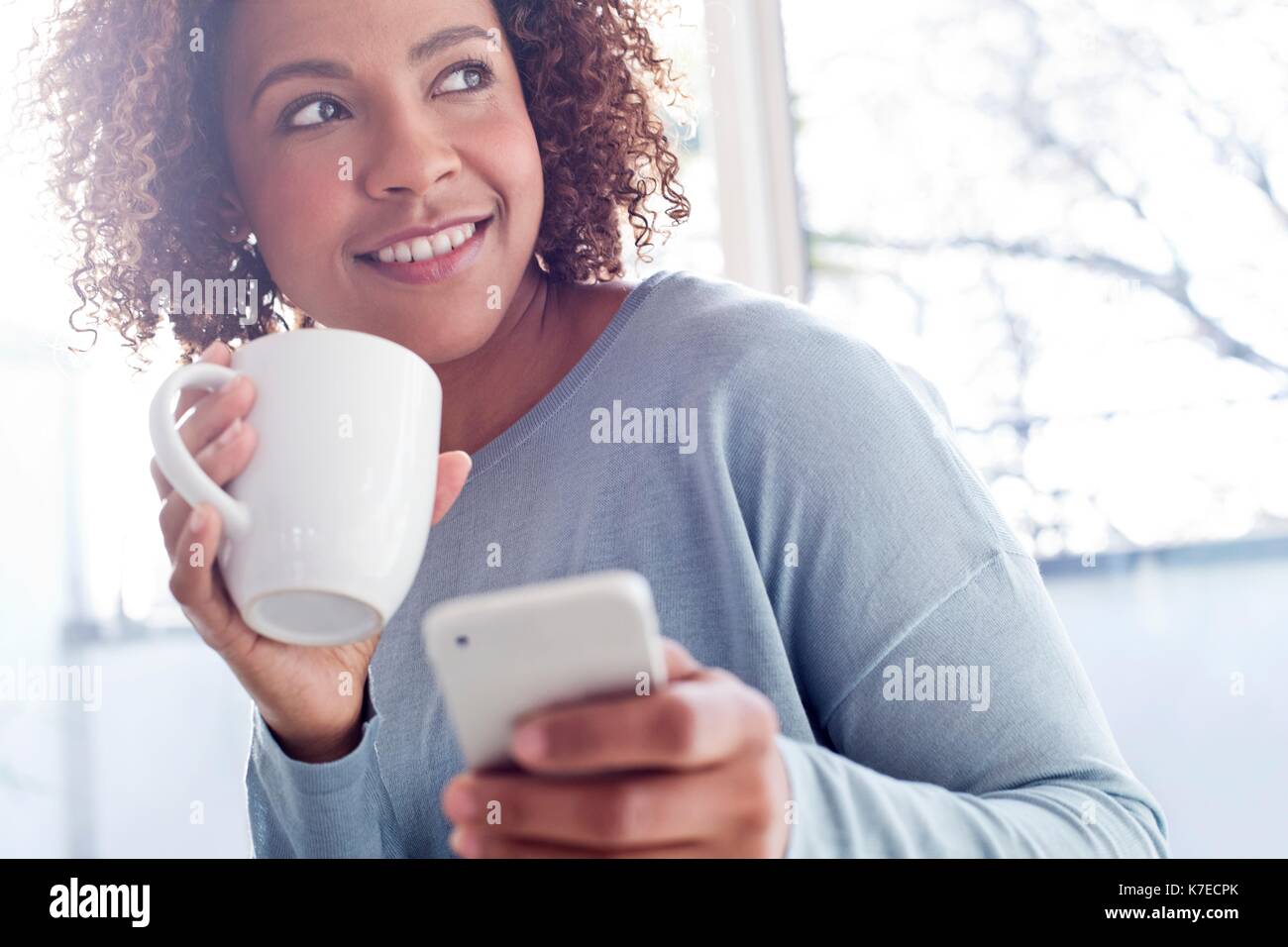 Woman with phone and coffee hi-res stock photography and images - Alamy