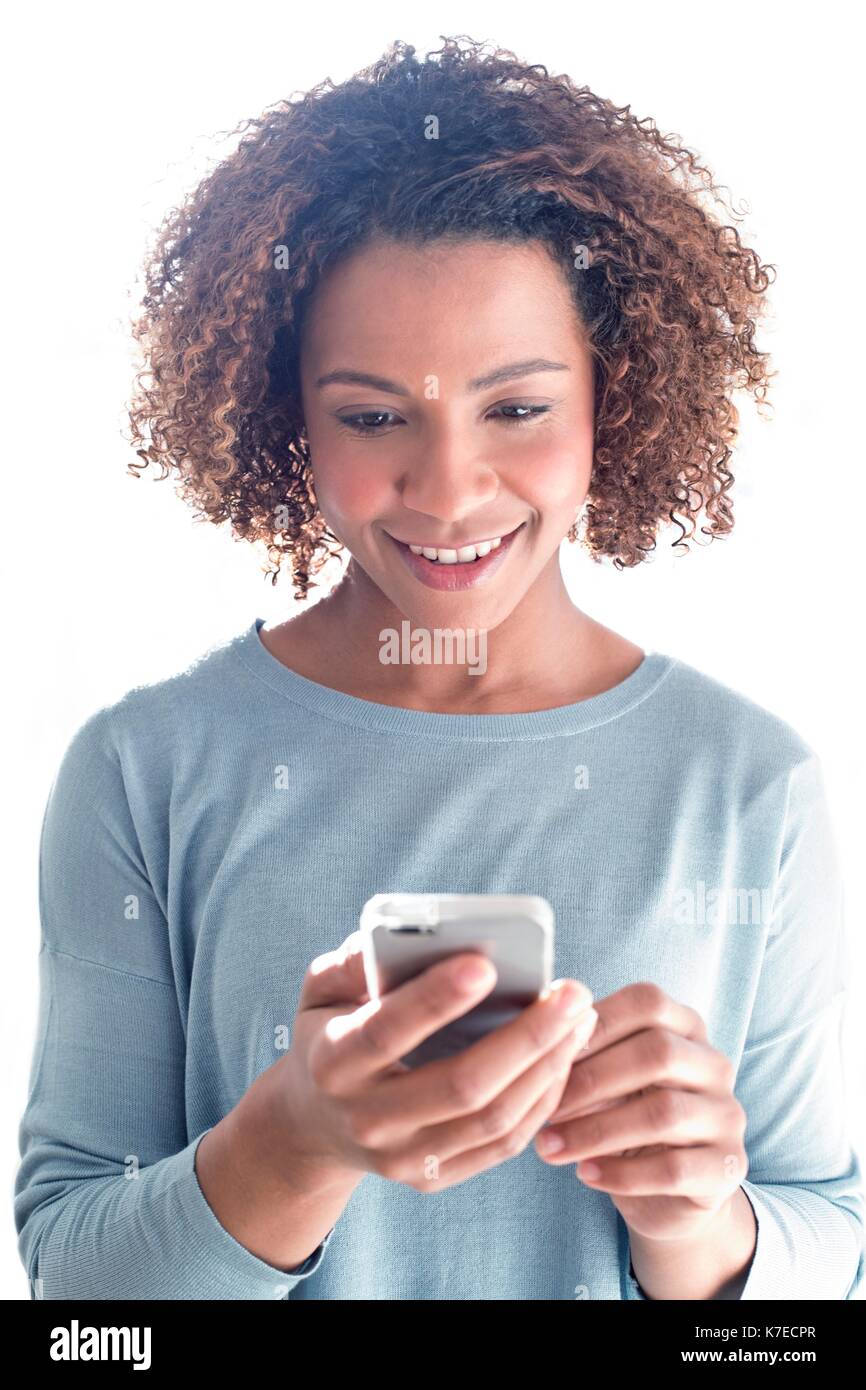 Mid adult woman using cell phone Stock Photo - Alamy
