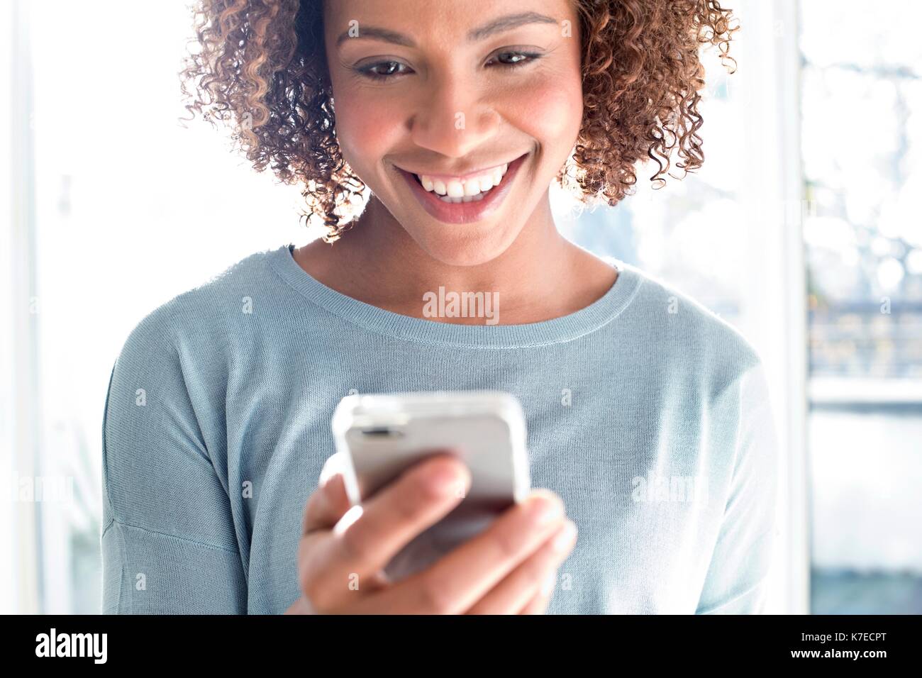 Mid adult woman using cell phone Stock Photo - Alamy