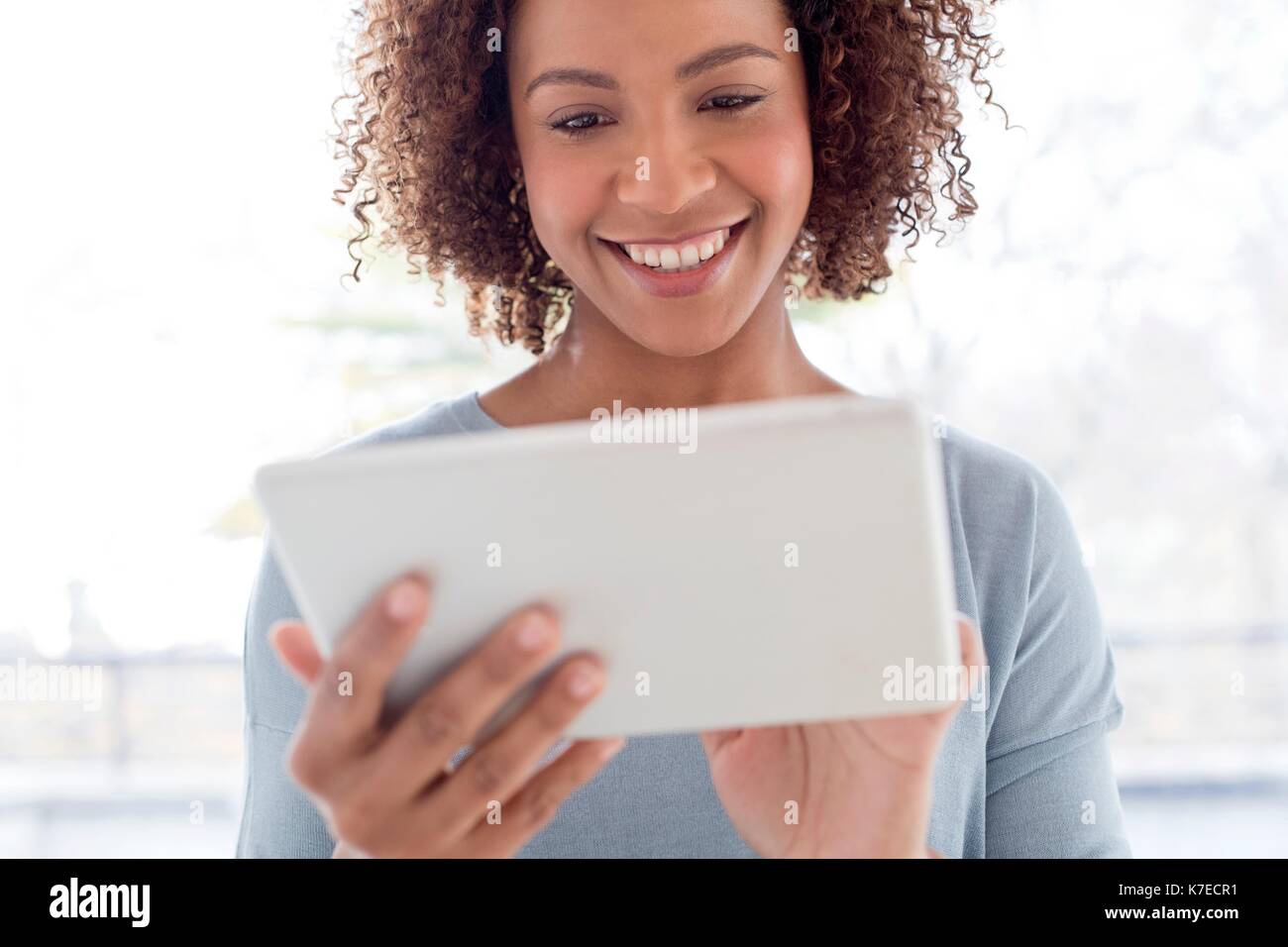 Mid adult woman using tablet hi-res stock photography and images - Alamy