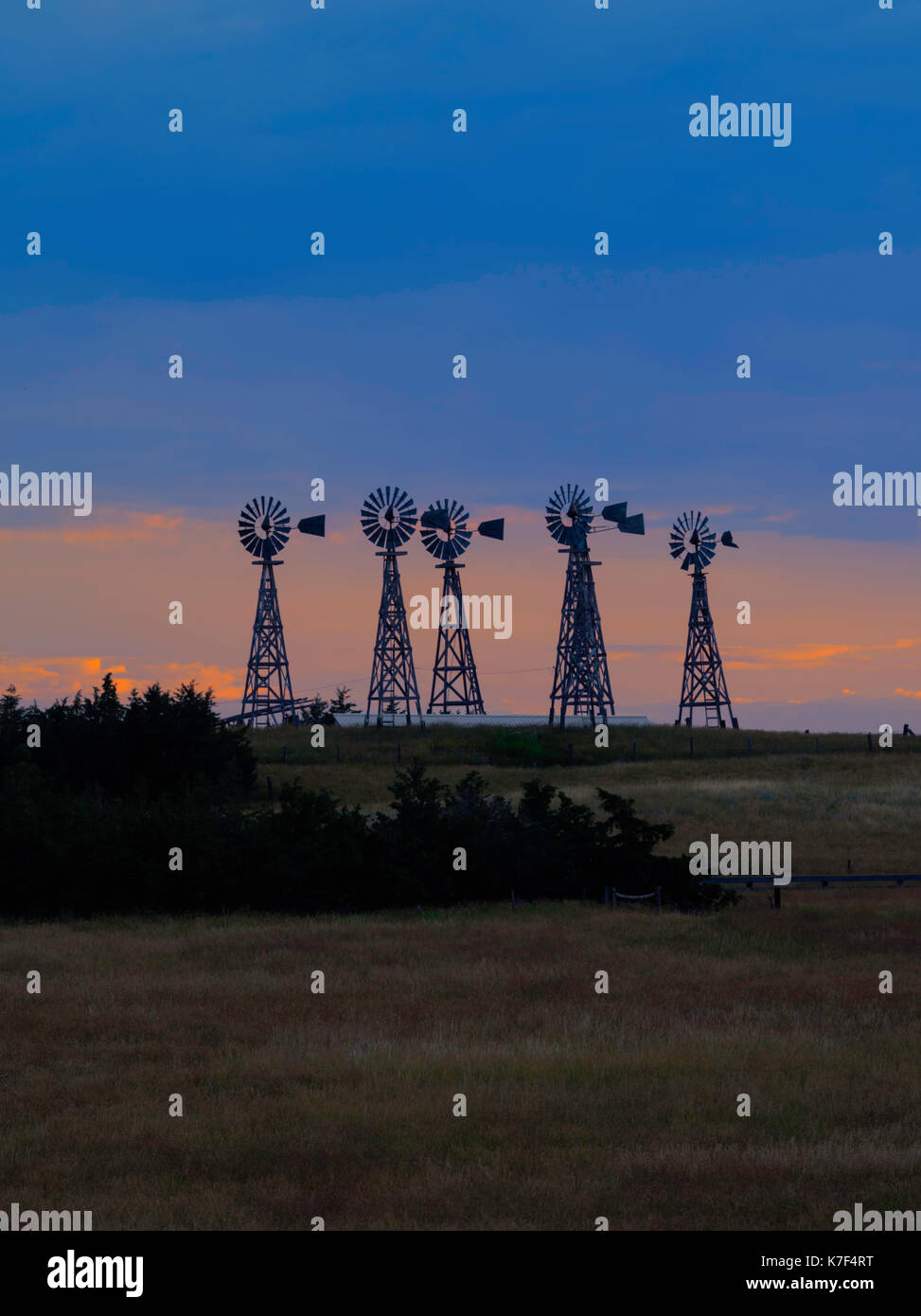 Photograph of windmilss on a ranch in western Nebraska, sunset Stock ...