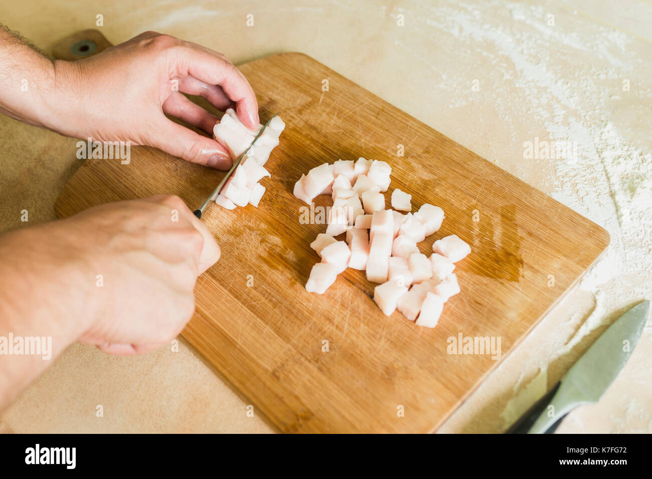 a man cuts raw pork fat into pieces Stock Photo - Alamy