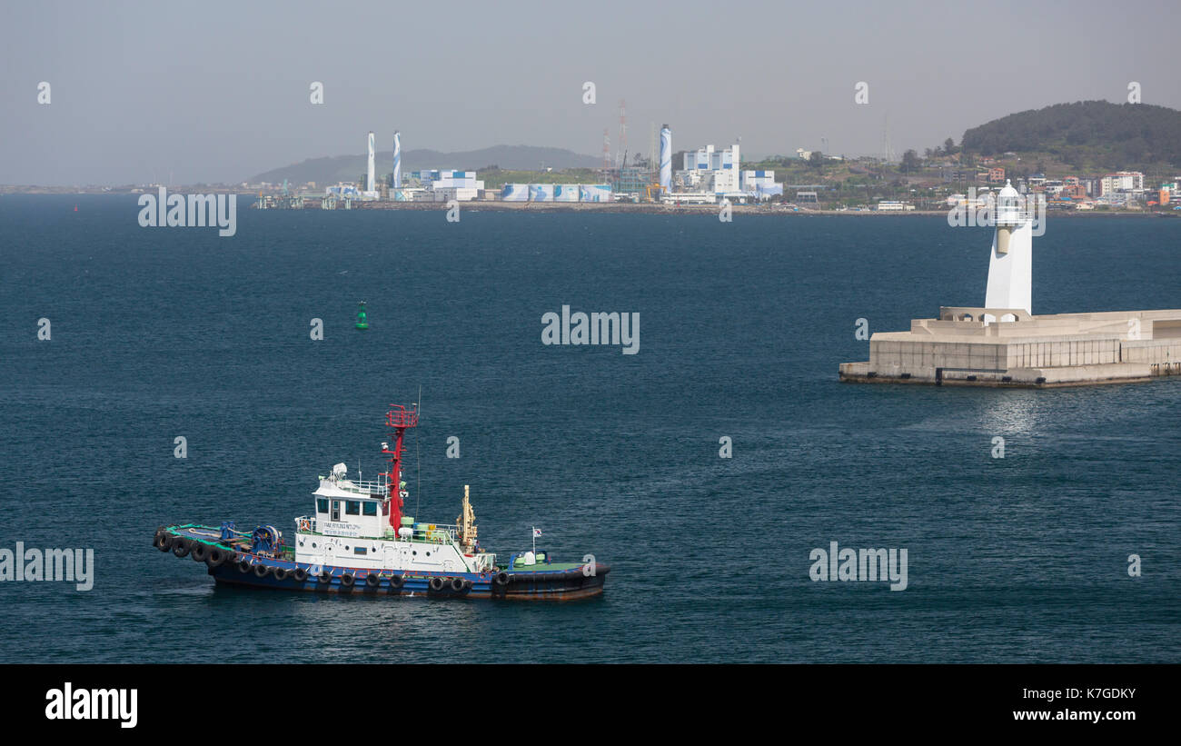 A tugboat in the harbor at the port of Jeju, Jeju Island, South Korea ...