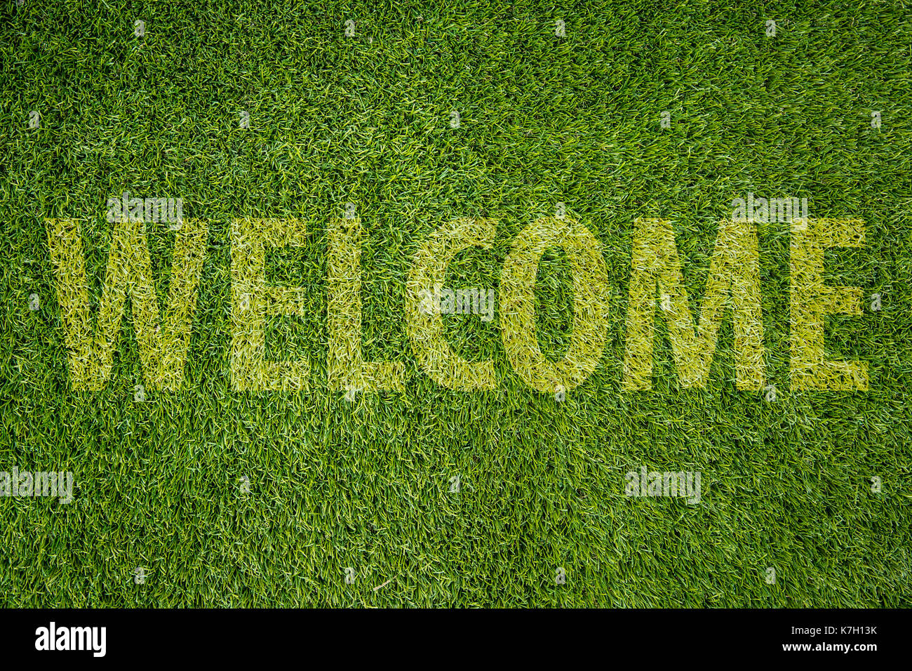green grass carpet welcome word Stock Photo - Alamy