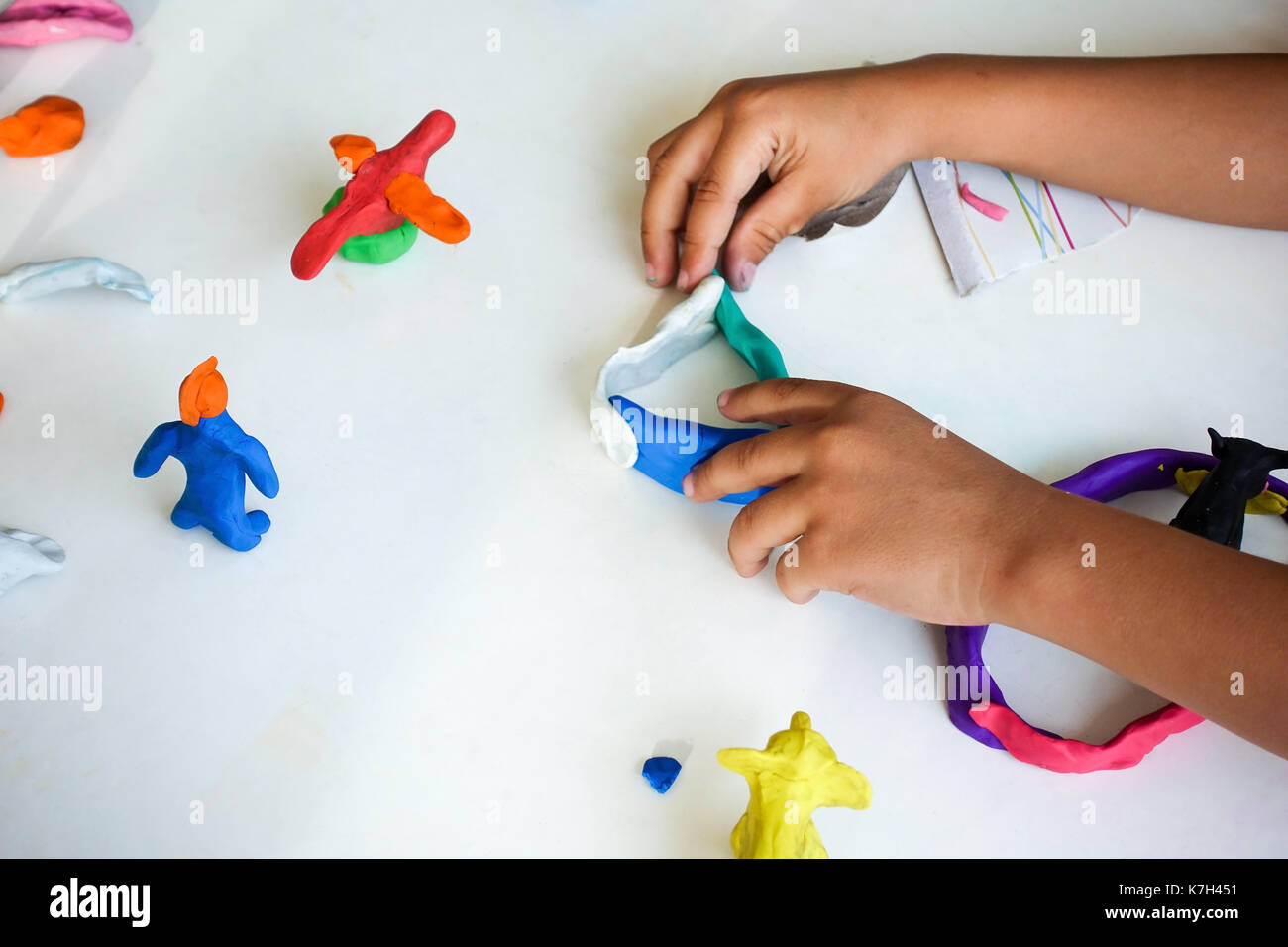 children learn and fun with modeling clay on white table Stock Photo ...