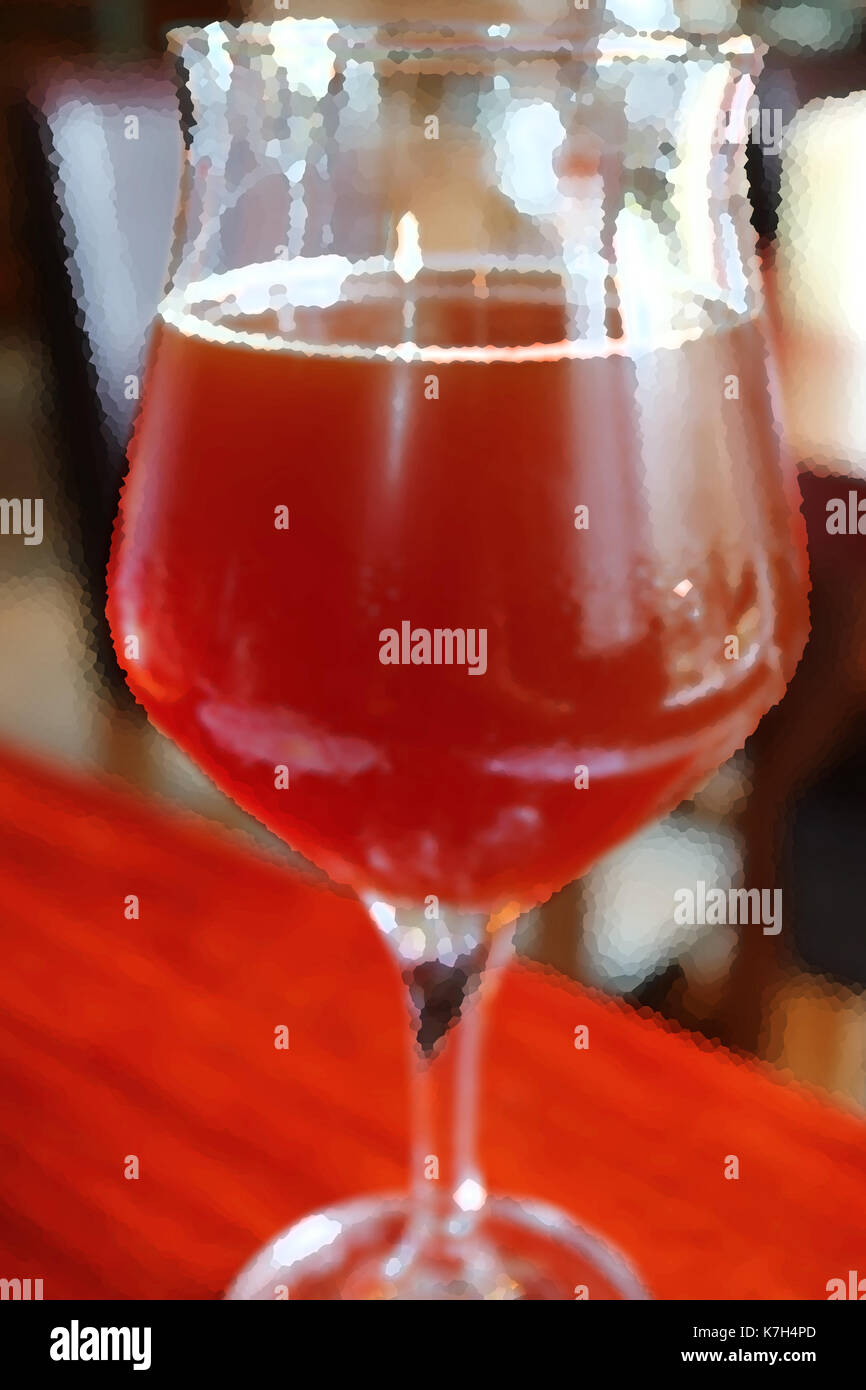 Blurred image of a glass of ruby color chilled craft beer, vertical ...