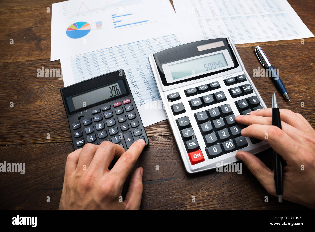 Businessman Analyzing Graph And Doing Financial Calculations Stock ...