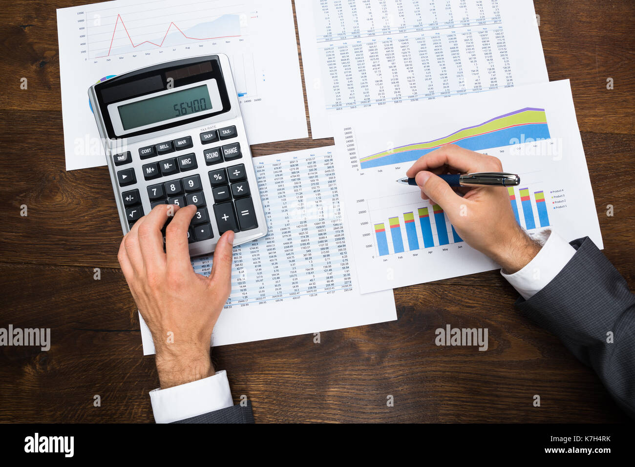 Businessman Analyzing Graph And Doing Financial Calculations Stock ...