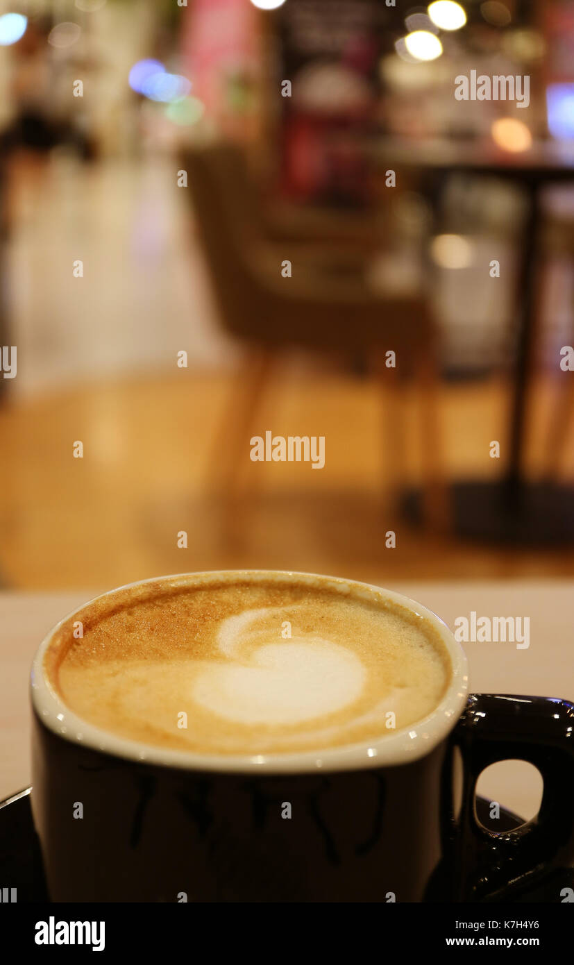 Closed up Coffee Foam of Hot Cappuccino in Black Cup, with Blurred ...