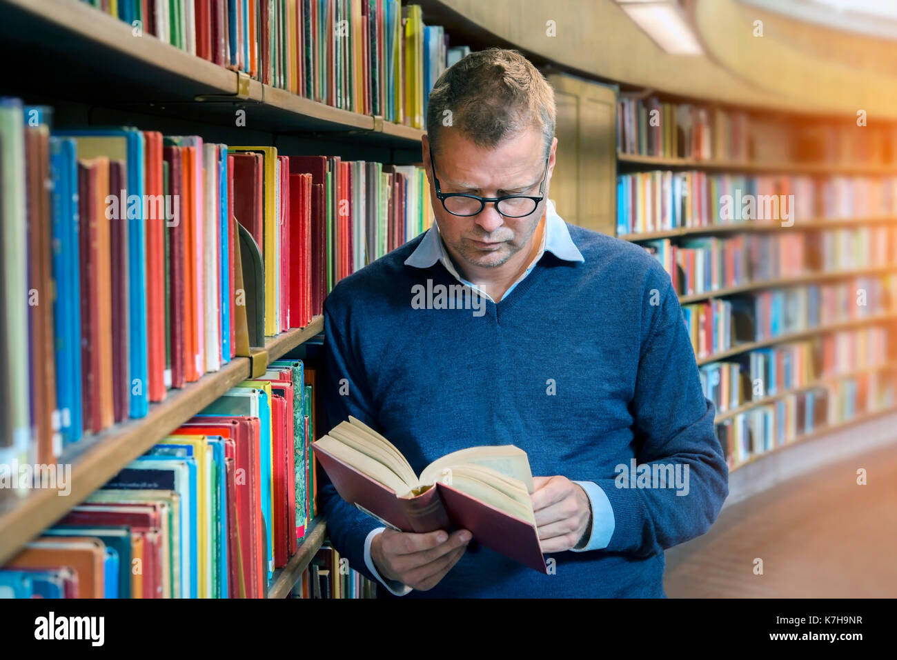 Man in hall reading paper hi-res stock photography and images - Alamy