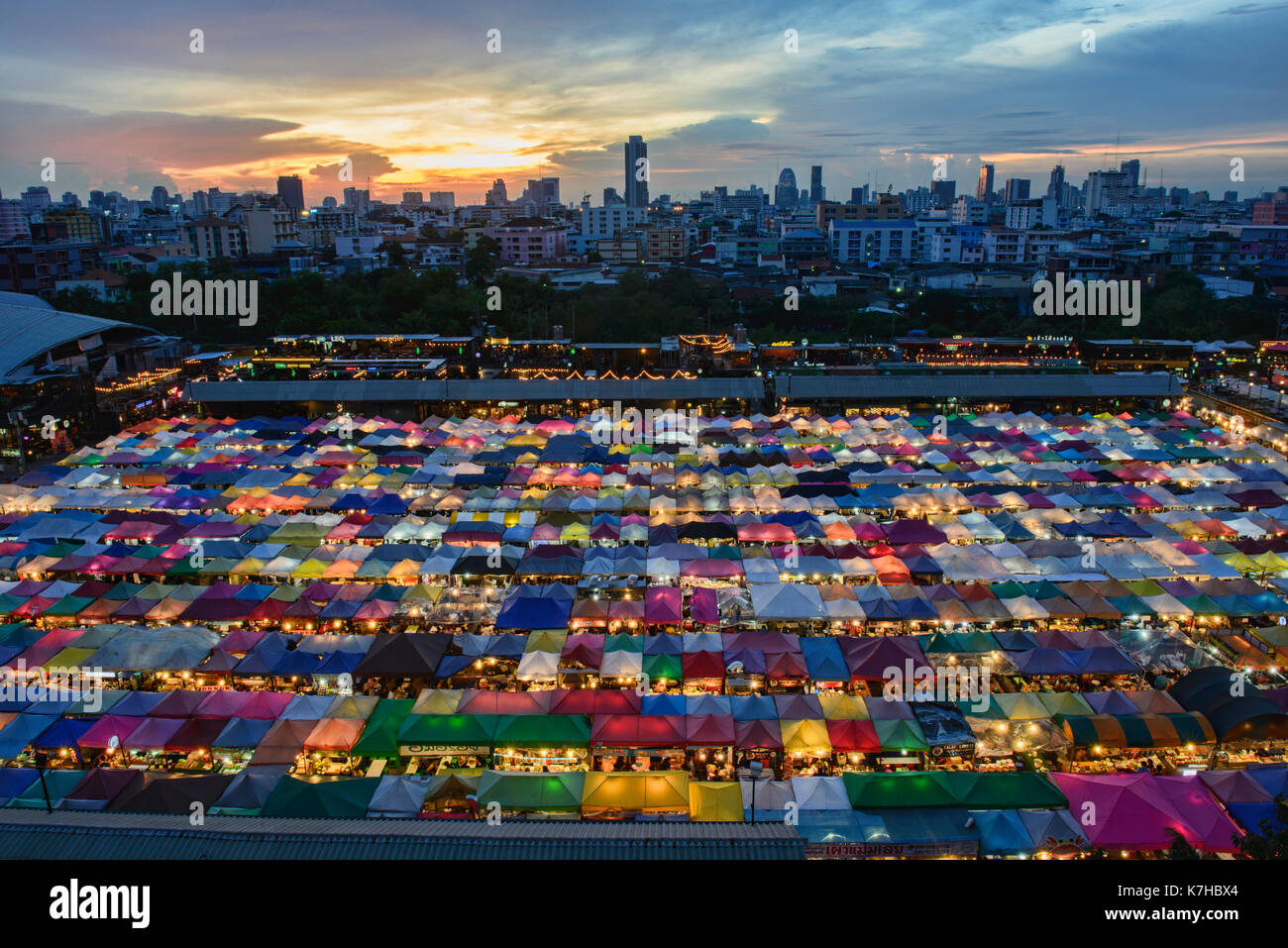 The colorful Ratchada Rot Fai Train Market at sunset, Bangkok, Thailand ...