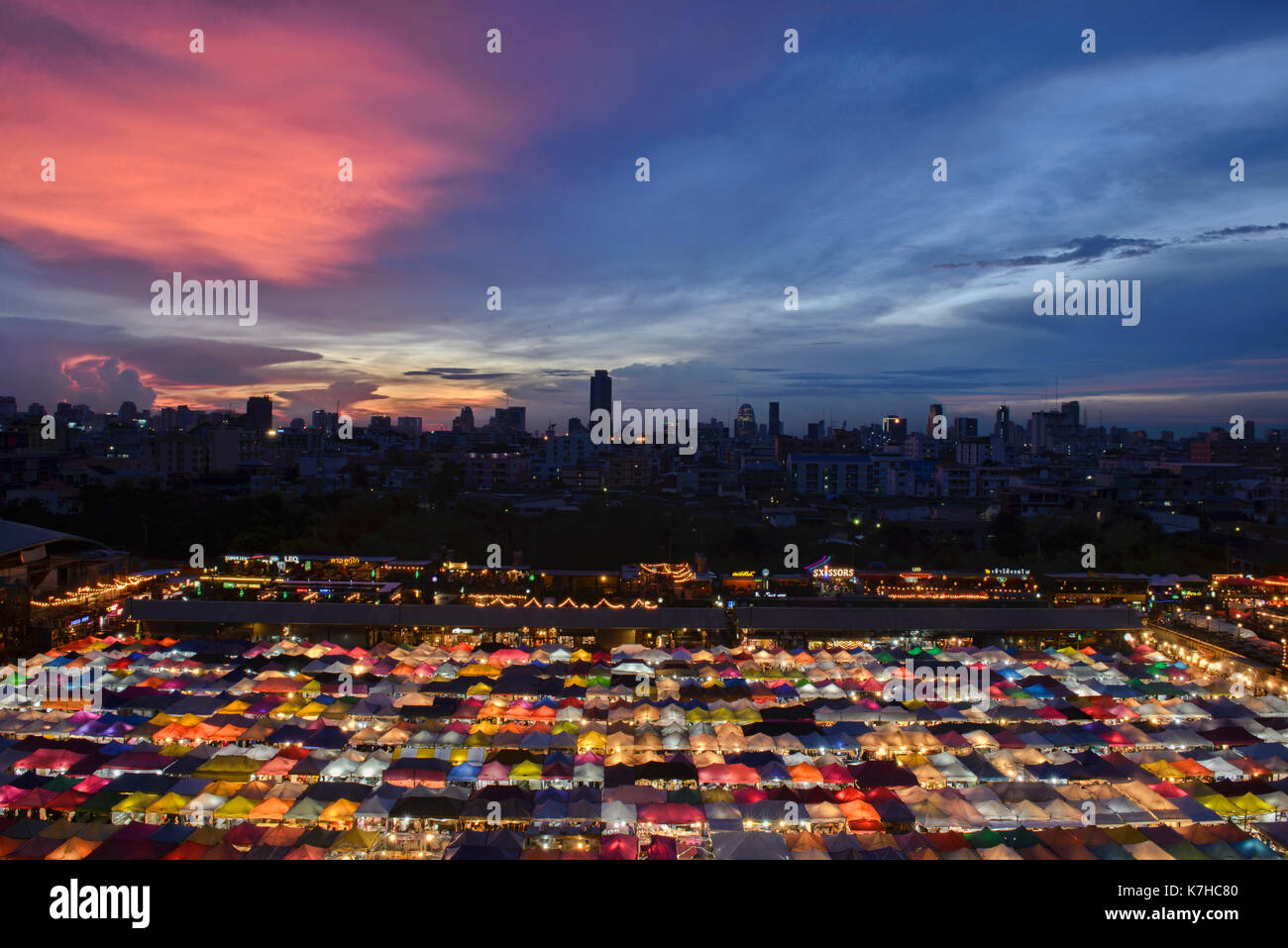 The colorful Ratchada Rot Fai Train Market at sunset, Bangkok, Thailand ...